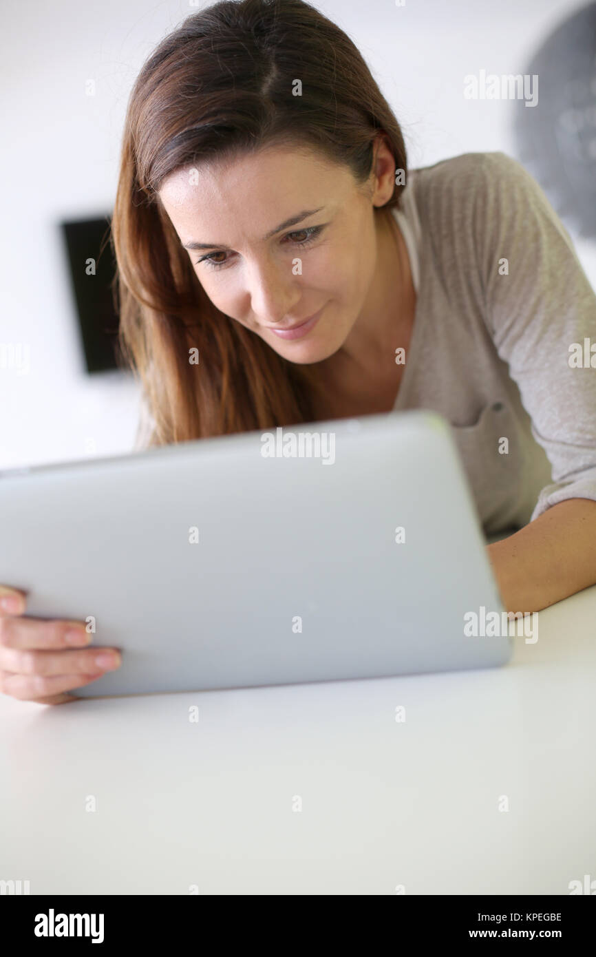 Young cheerful woman using electronic tablet Stock Photo - Alamy