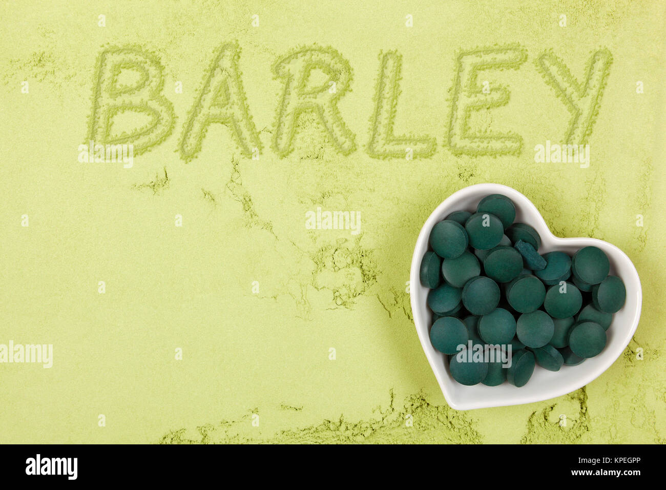 Green food supplement. Word barley written in green ground powder, top ...