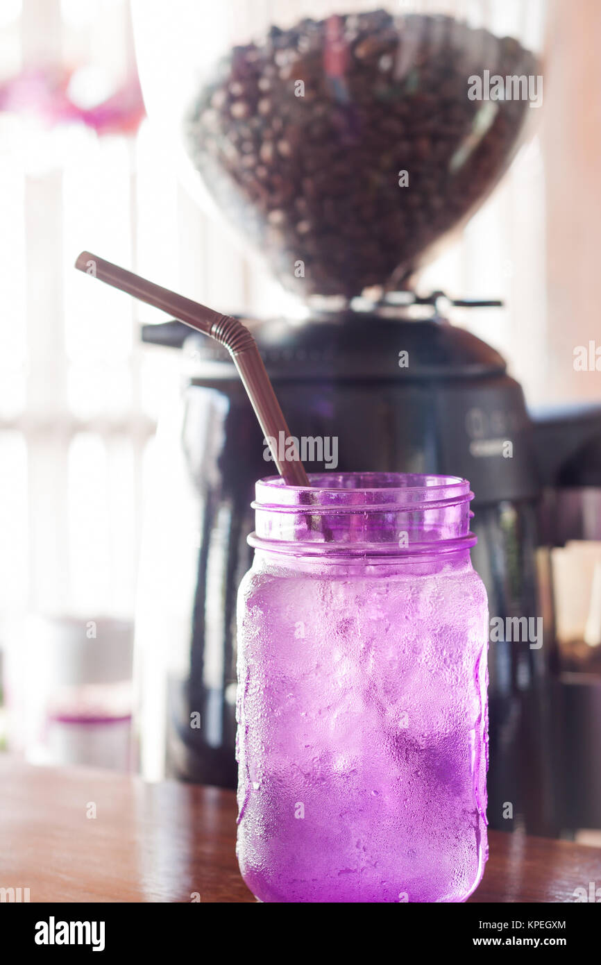 Iced drink in violet glass in coffee shop Stock Photo - Alamy
