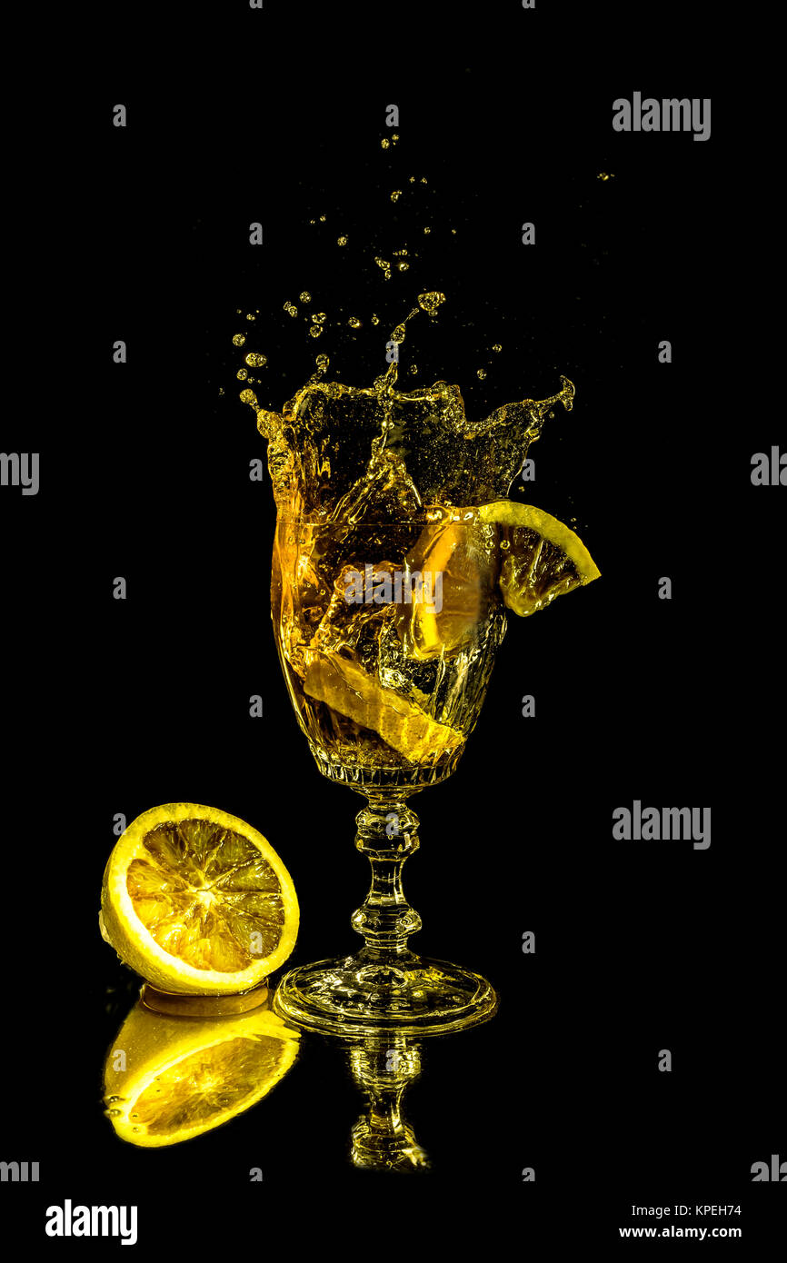 Lemon piece falls into a champagne glass Stock Photo - Alamy