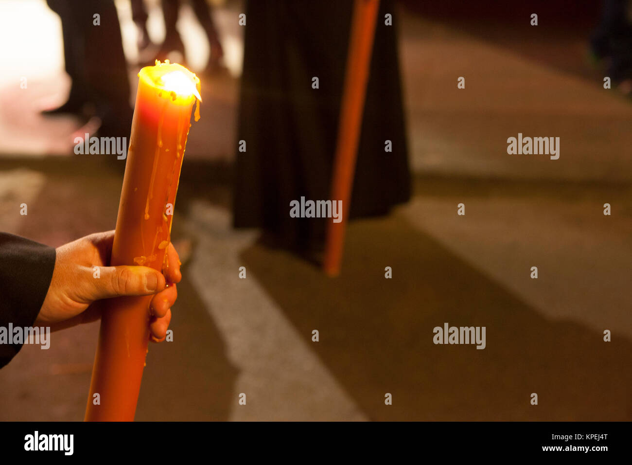 Nazareno holding large candle at Holy Week, Spain Stock Photo - Alamy