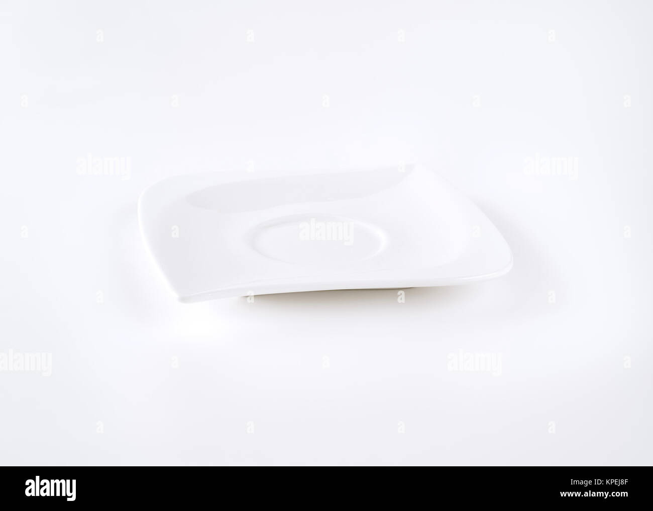 Stylish wave shaped white saucer Stock Photo - Alamy