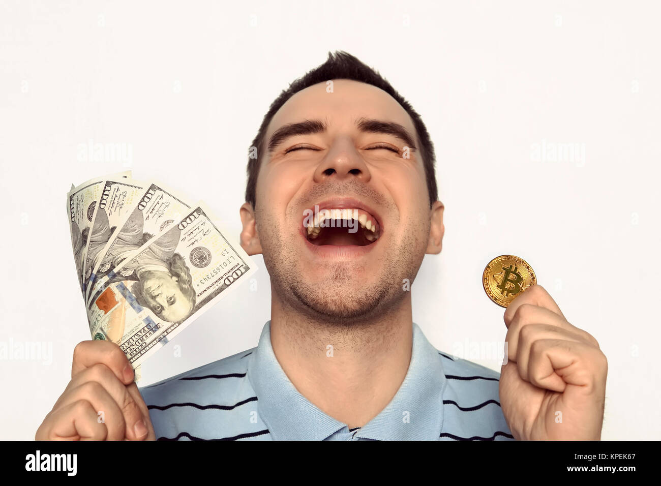 Happy cheerful young businessman holding big bitcoin on white ...