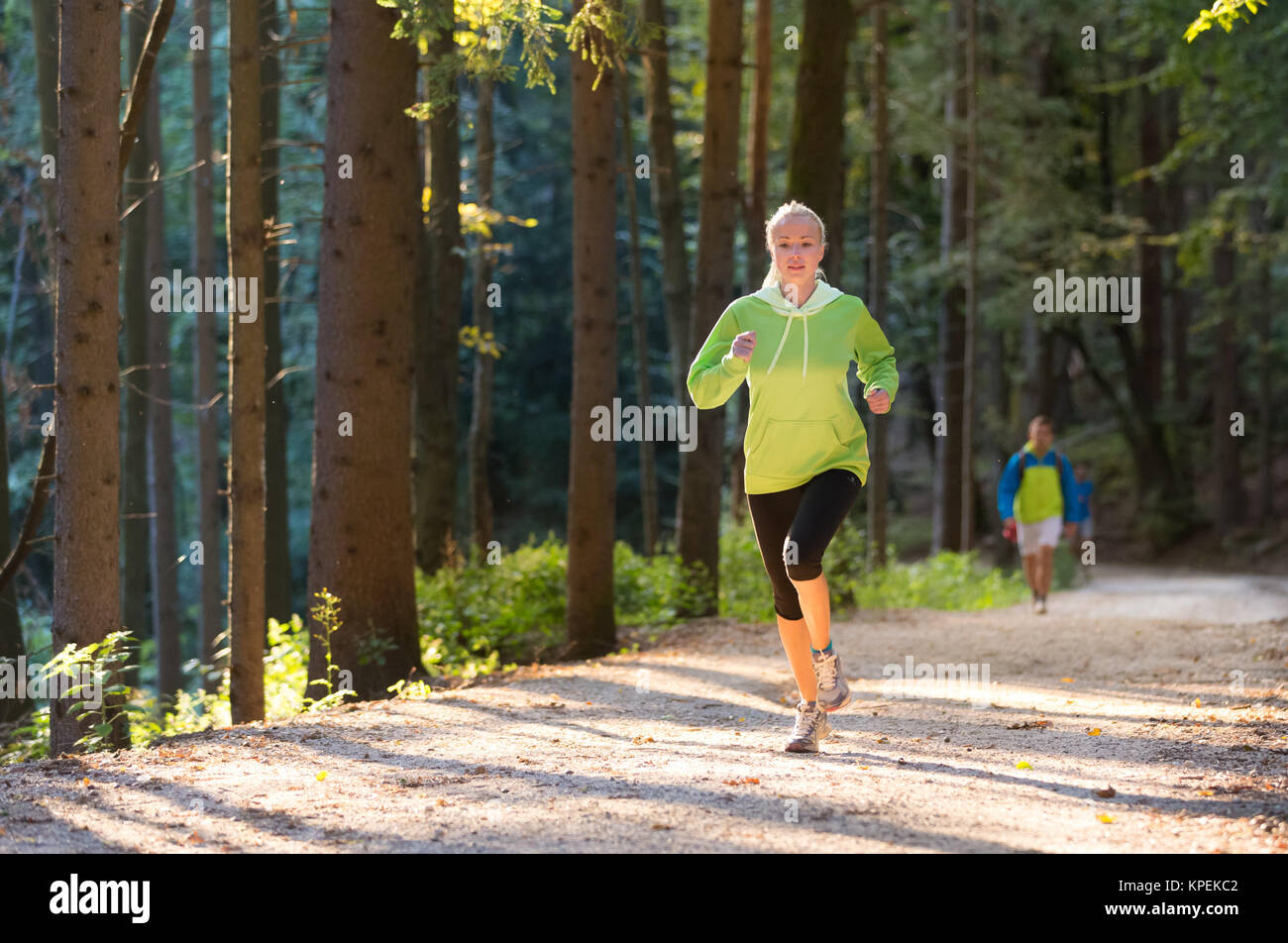 Pretty young girl runner in the forest Stock Photo - Alamy