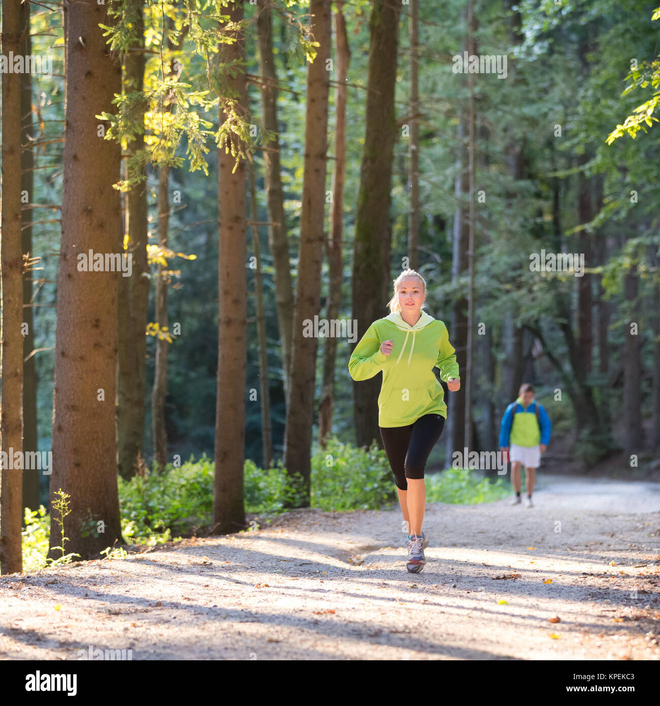 Pretty young girl runner in the forest Stock Photo - Alamy
