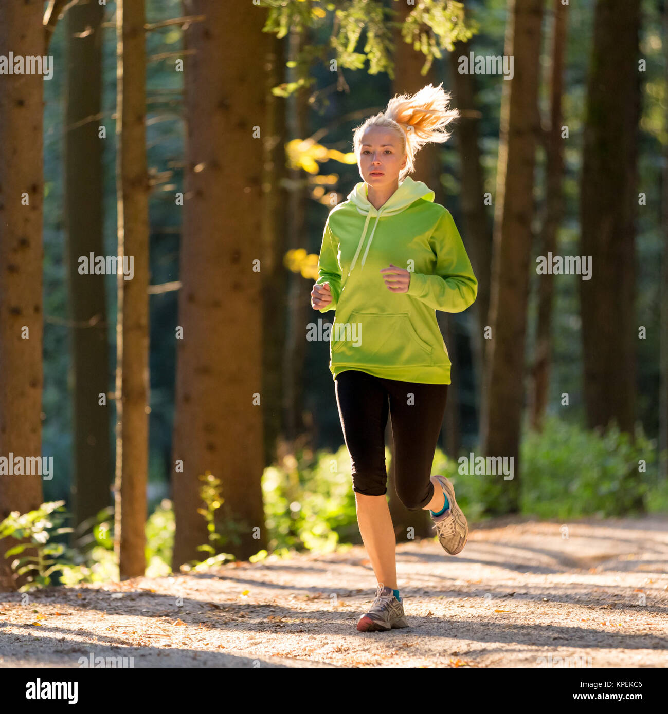Pretty young girl runner in the forest Stock Photo - Alamy