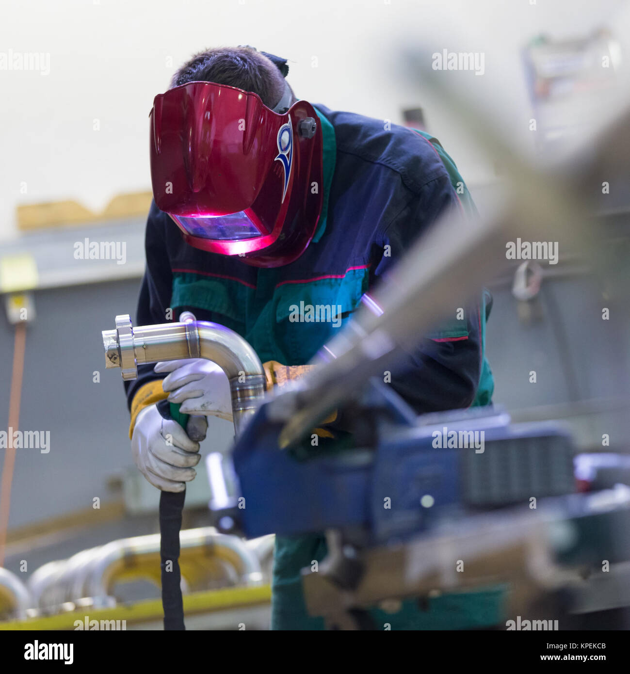 Industrial worker welding in metal factory Stock Photo - Alamy