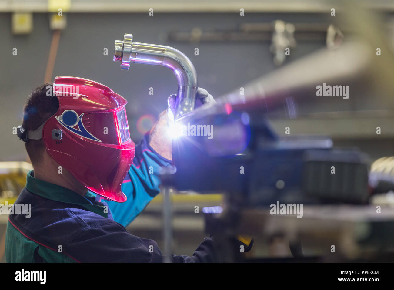 Industrial worker welding in metal factory Stock Photo - Alamy