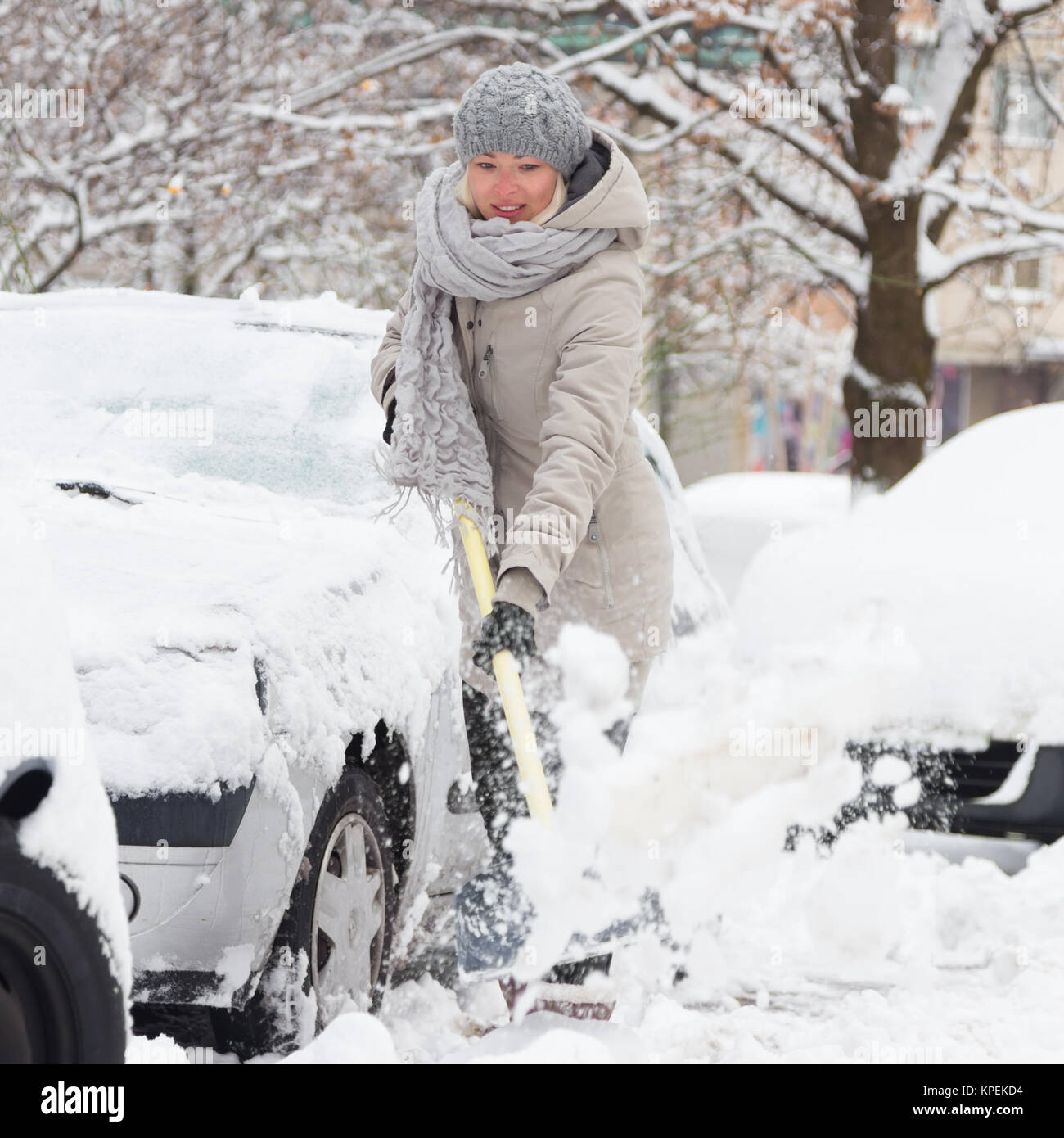 Independent woman shoveling snow in winter Stock Photo - Alamy