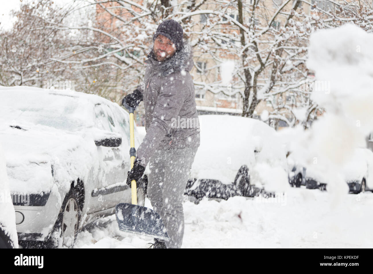 Man shoveling snow in winter Stock Photo - Alamy