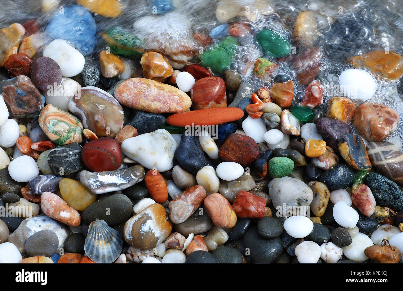 Colorful pebbles in the sea wave Stock Photo - Alamy