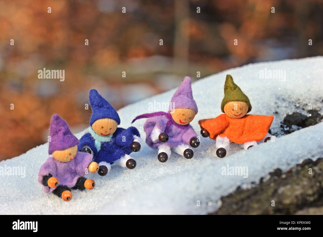 Four little gnomes sit in the snow Stock Photo - Alamy