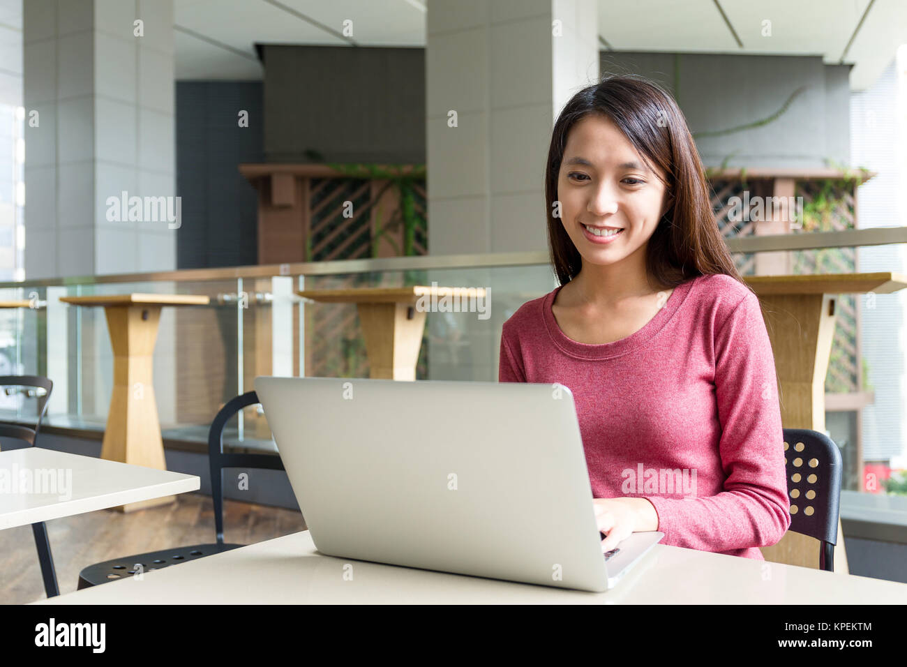 Smiling woman browsing the internet Stock Photo - Alamy