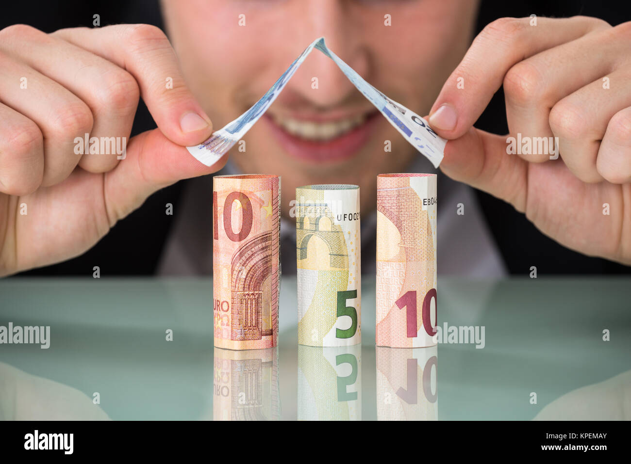 Businessman Making House Of Banknotes Stock Photo - Alamy