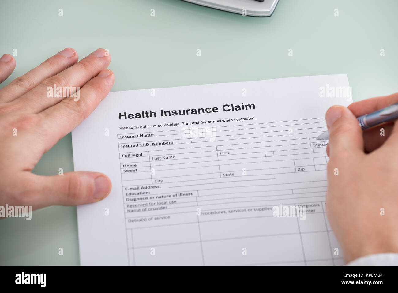 Person Hand Over Health Insurance Claim Form Stock Photo - Alamy