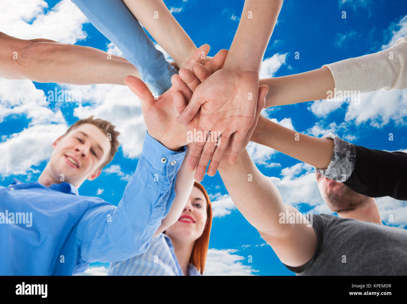 Group of people stacking hands together Stock Photo - Alamy