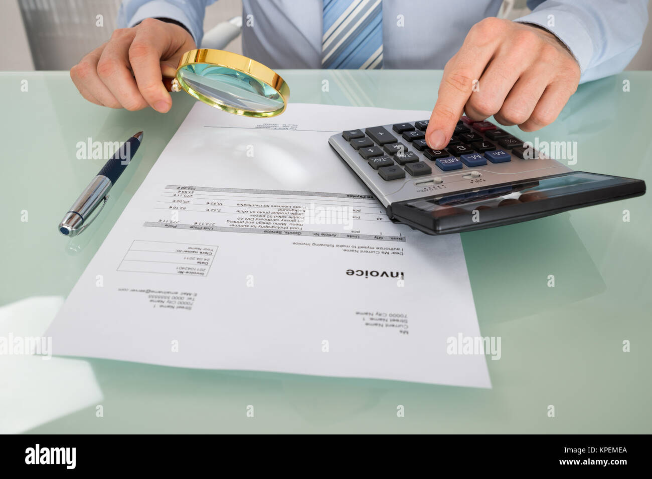Businessman Checking Invoice With Magnifying Glass Stock Photo - Alamy