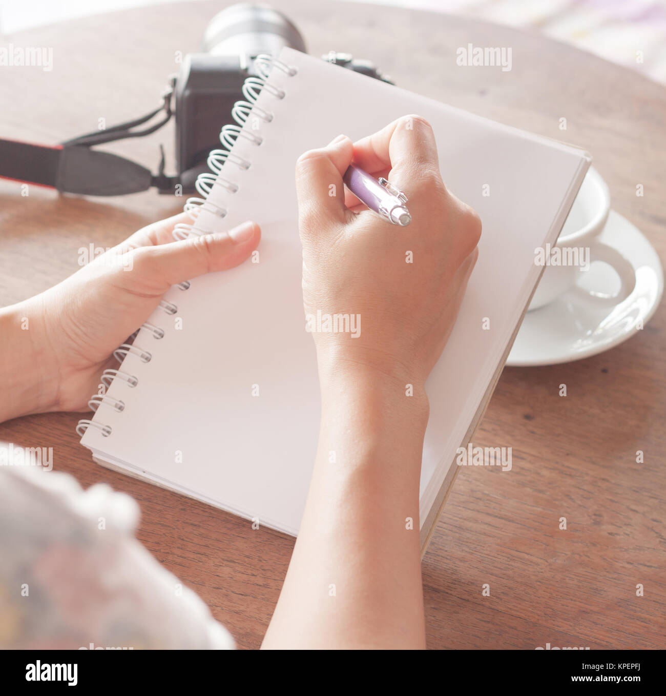 Woman hand with pen writing on notebook Stock Photo - Alamy