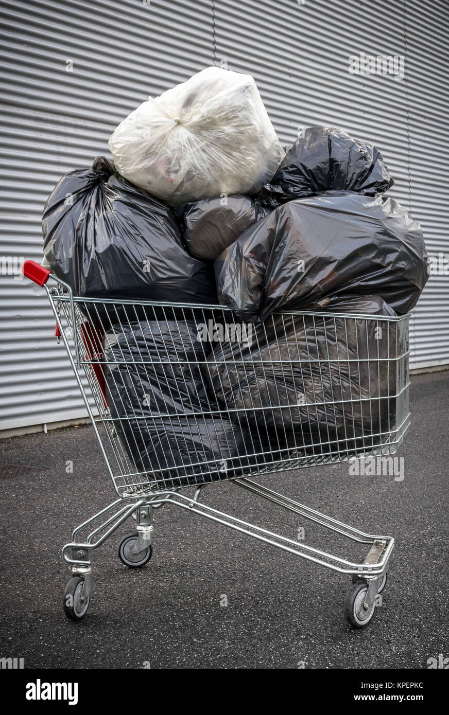 Shopping cart with garbage bags Stock Photo - Alamy