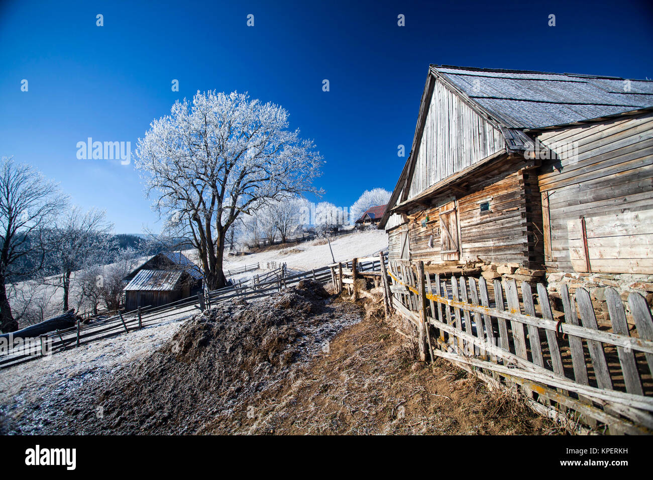 Winter rural landscape with cottage on the hill Stock Photo - Alamy