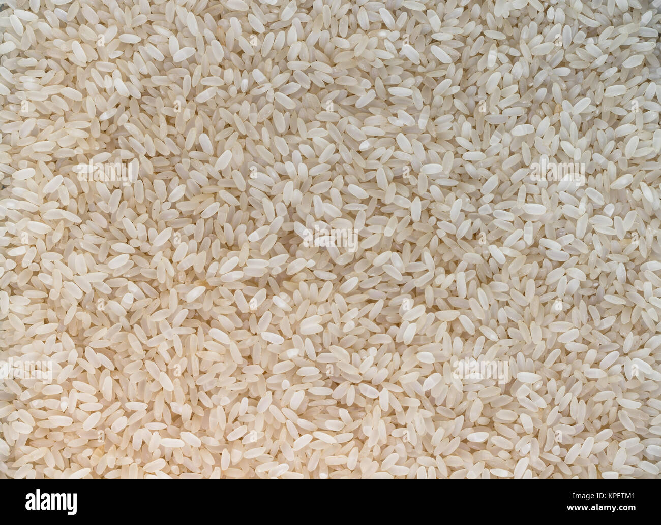 Uncooked rice background Stock Photo - Alamy