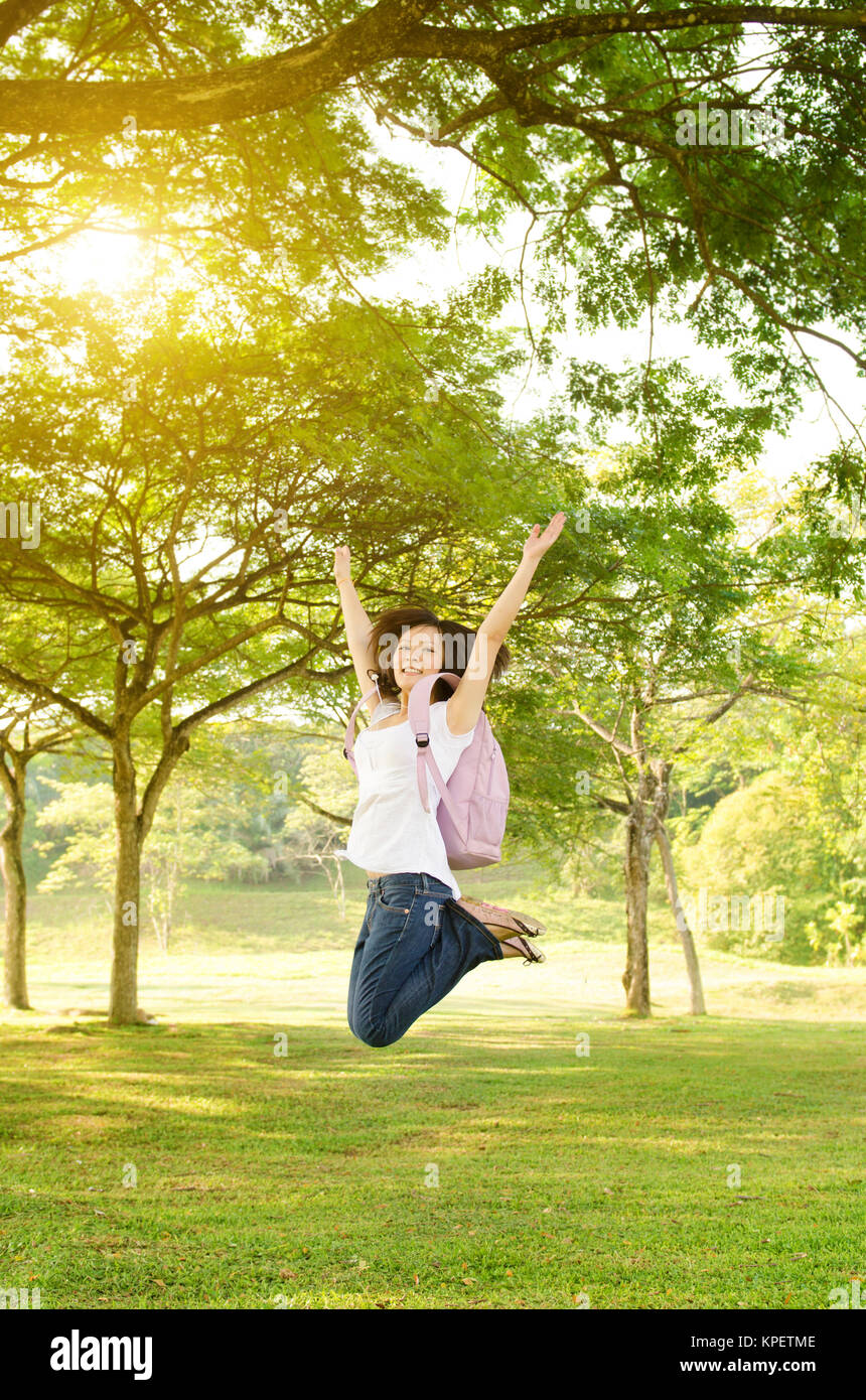 Young Asian college girl student open arms jumping Stock Photo - Alamy