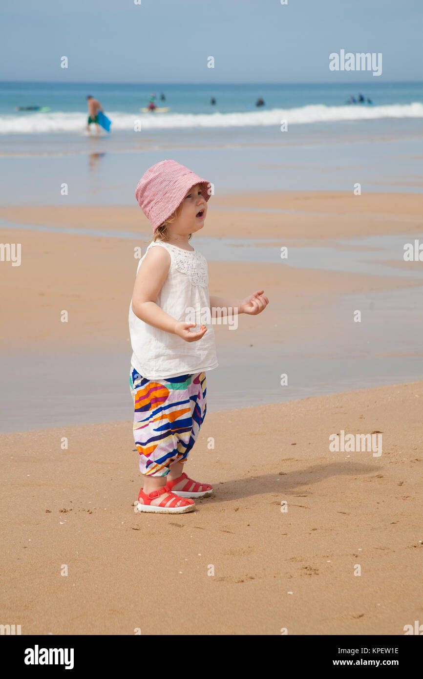 baby at beach asking Stock Photo - Alamy
