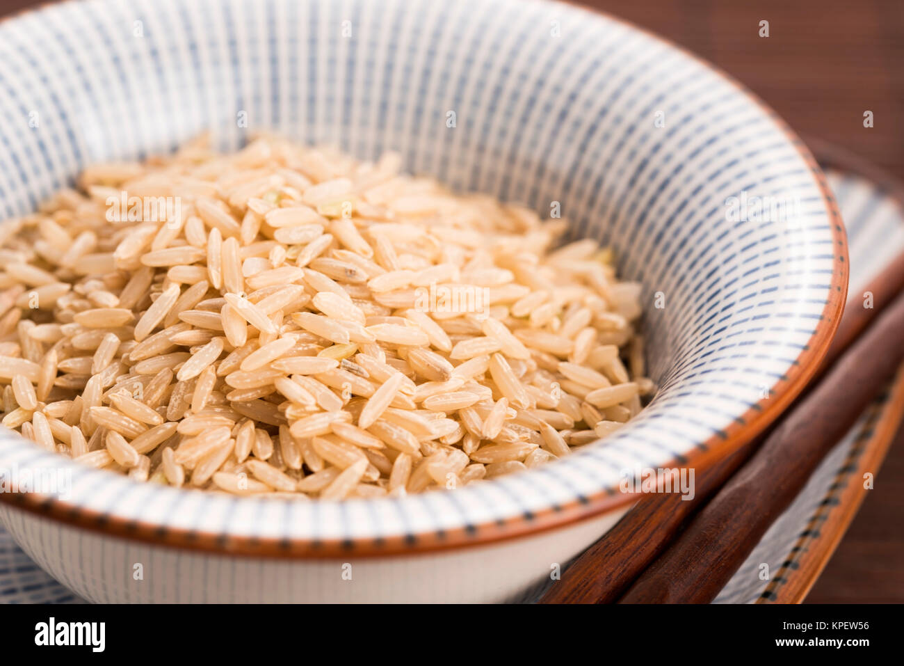 Raw brown rice in a bowl Stock Photo - Alamy