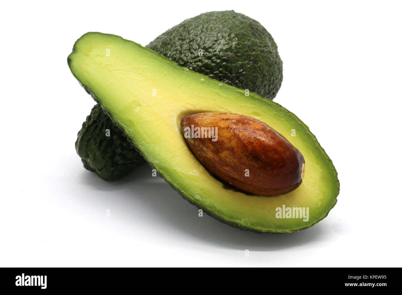 One whole and one sliced avocado Stock Photo - Alamy