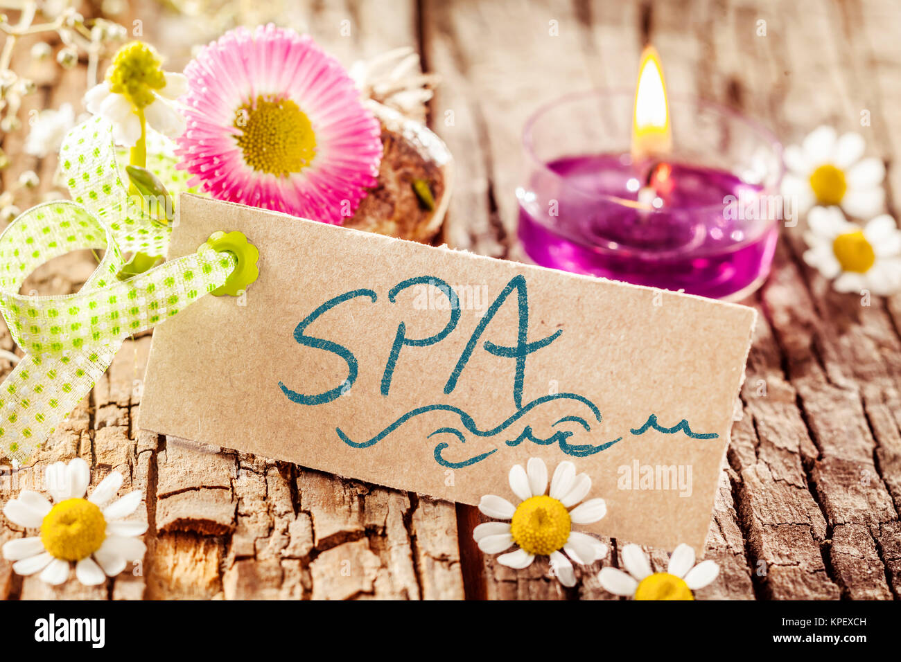 Sweet smelling display of handwritten spa sign placed on tree bark ...