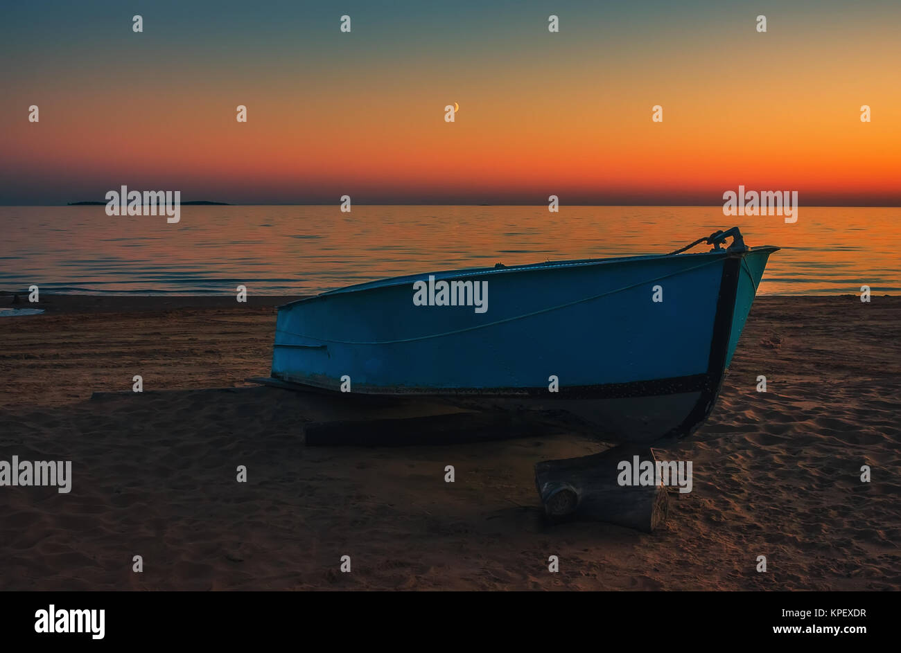 Boat on the beach at sunset background Stock Photo - Alamy