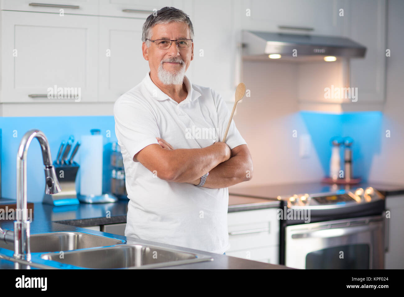 Senior man standing in his renovated, modern kitchen Stock Photo - Alamy