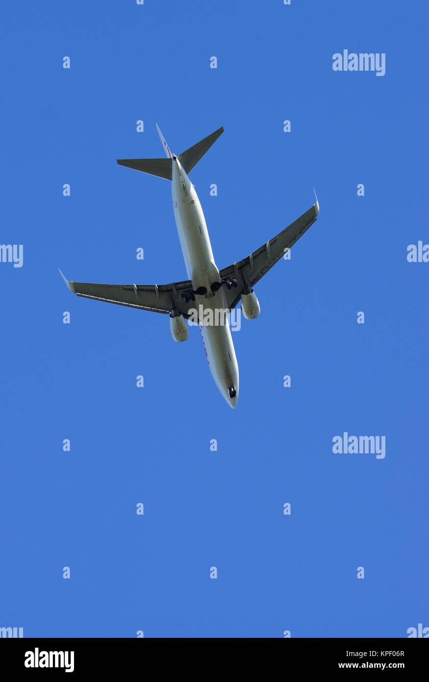 Plane under blue sky Stock Photo - Alamy