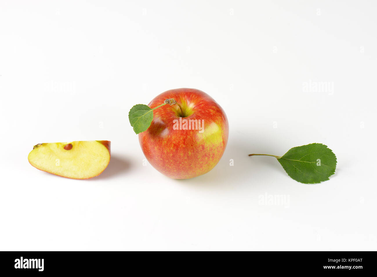 one whole apple and one quarter piece Stock Photo - Alamy