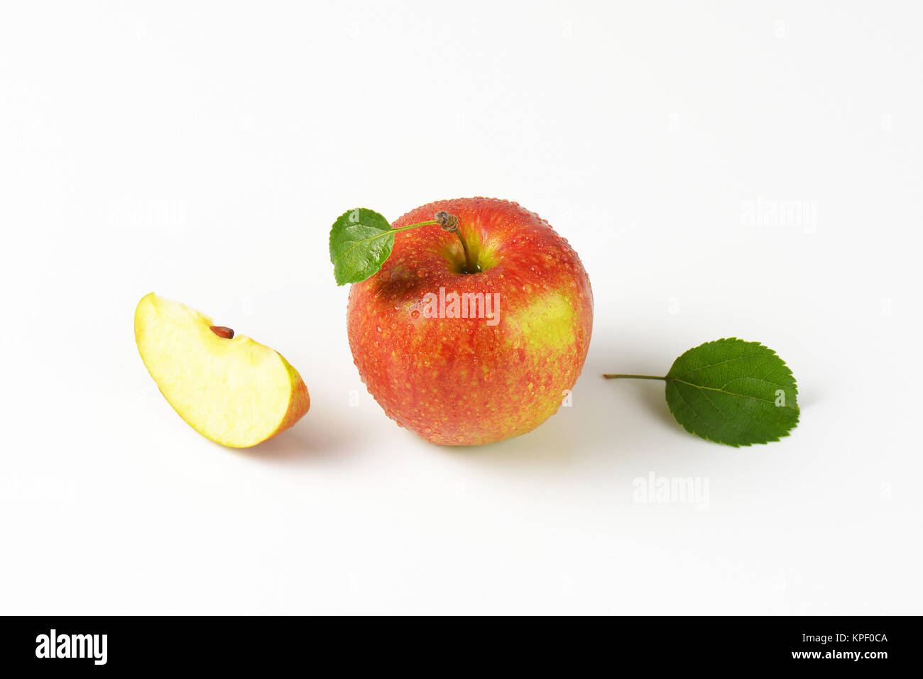 one whole apple and one quarter piece Stock Photo - Alamy