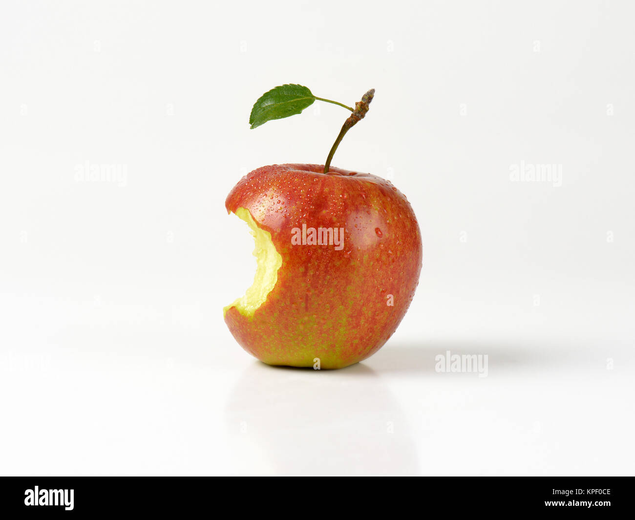 Red apple with a bite taken Stock Photo - Alamy