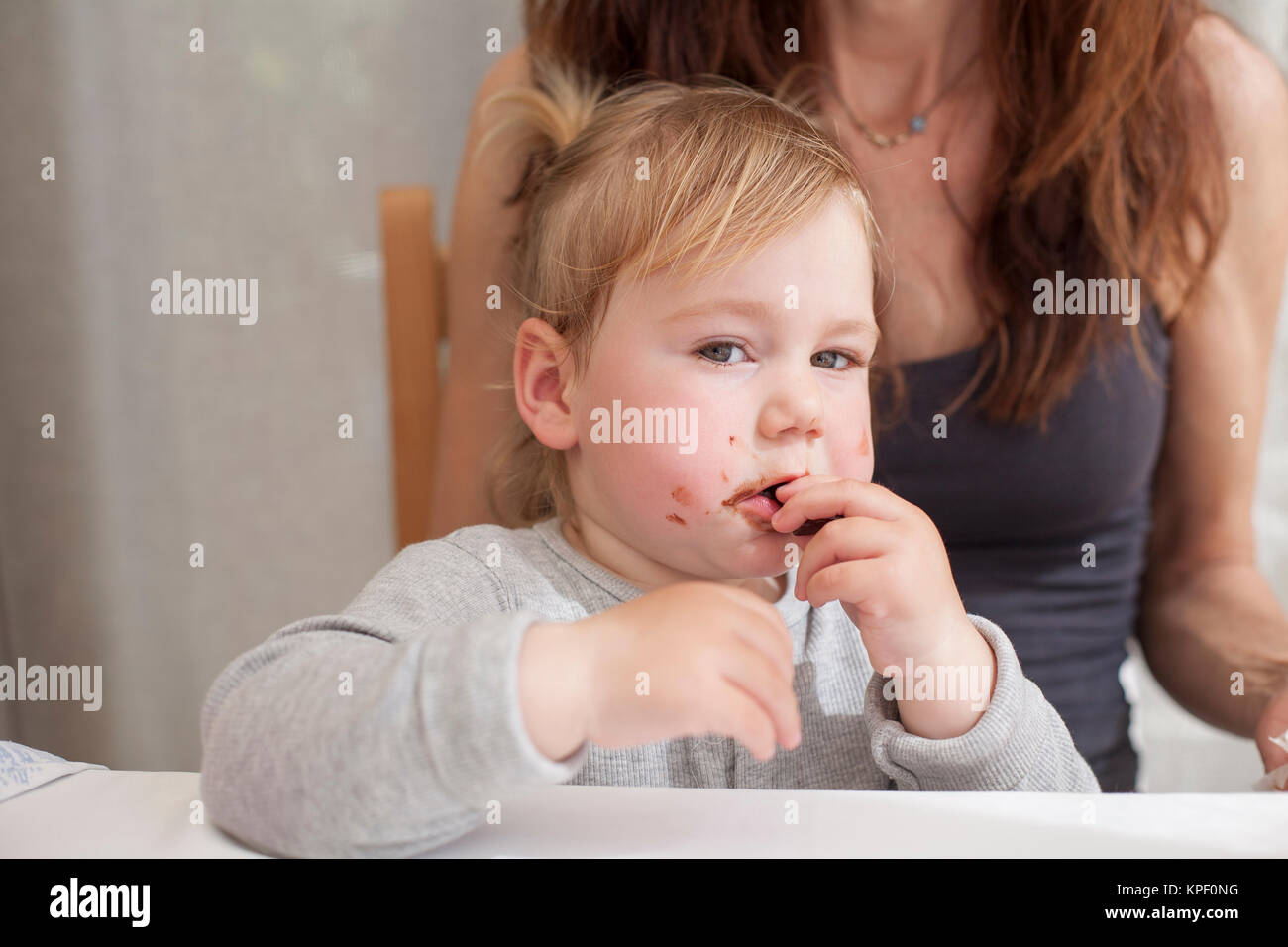 baby biting chocolate Stock Photo - Alamy
