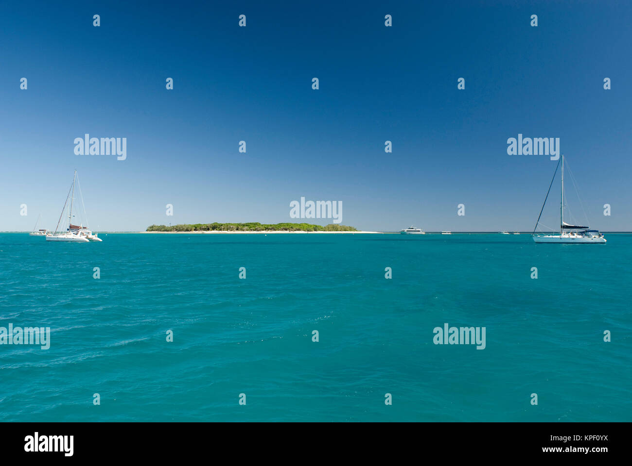 Idyllic island and two boats Stock Photo - Alamy