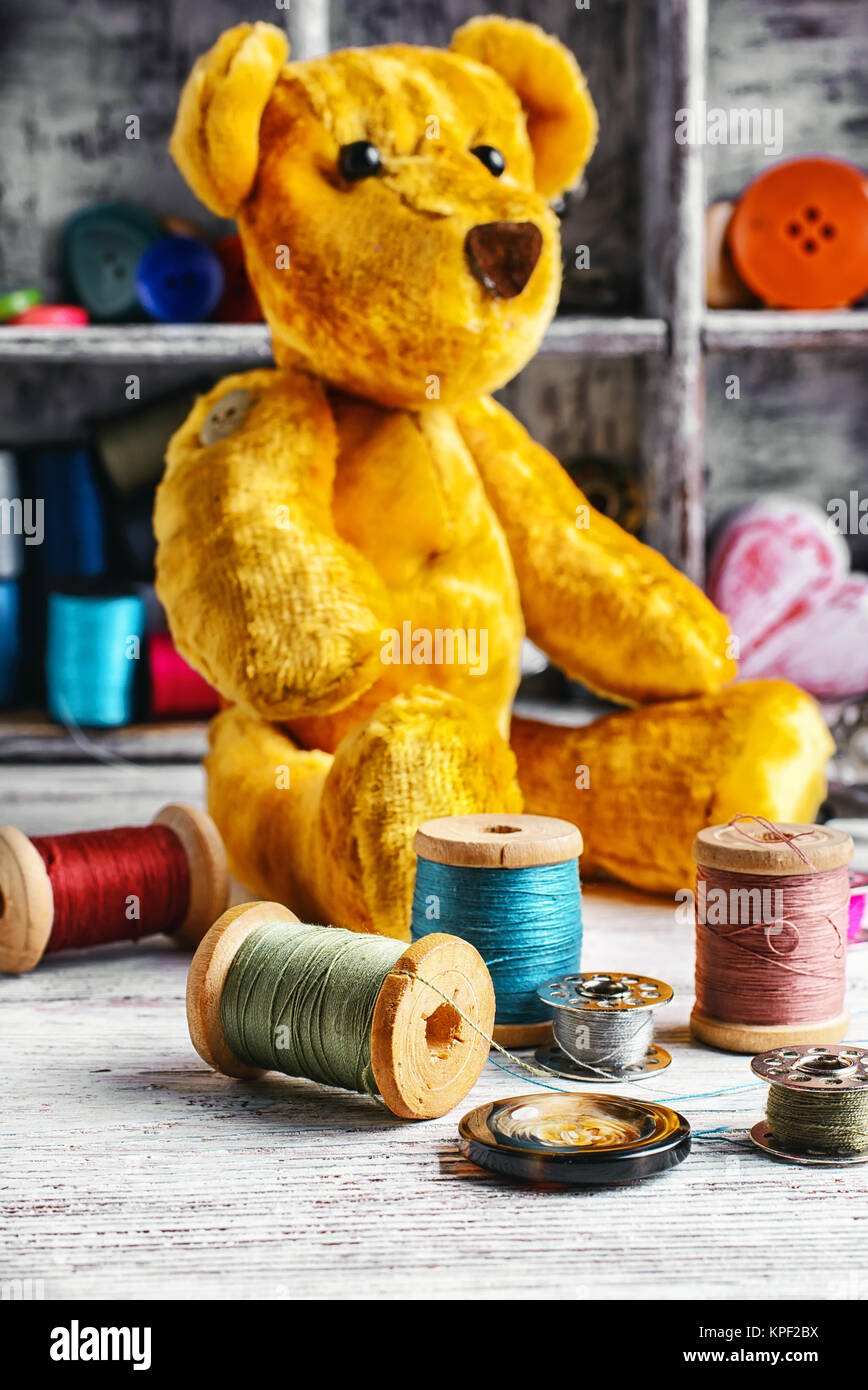 Made by hand toy bear on the background of tools for needlework Stock ...