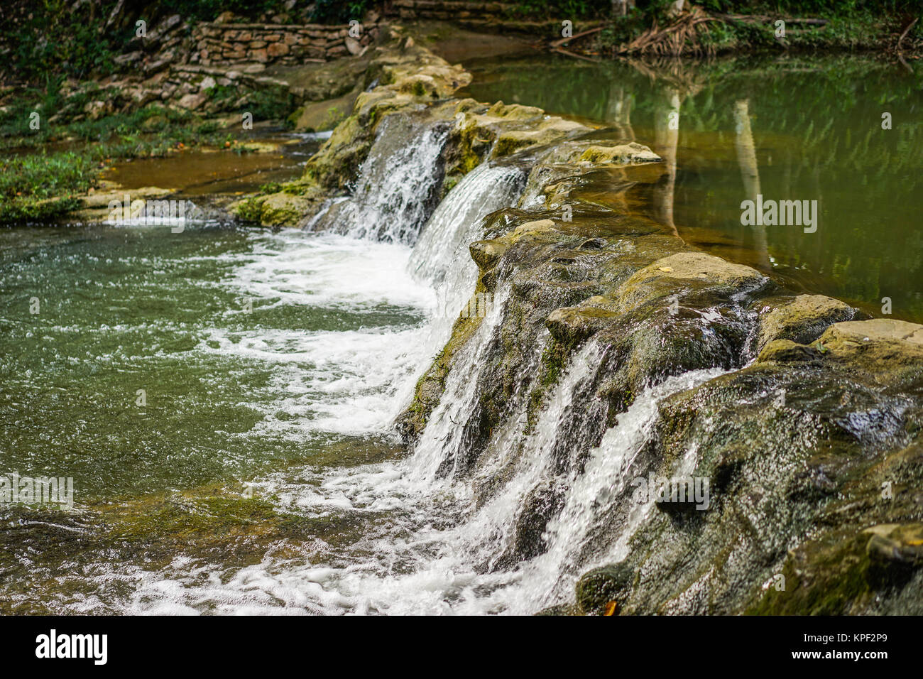 Small Waterfall by the Lake Stock Photo - Alamy