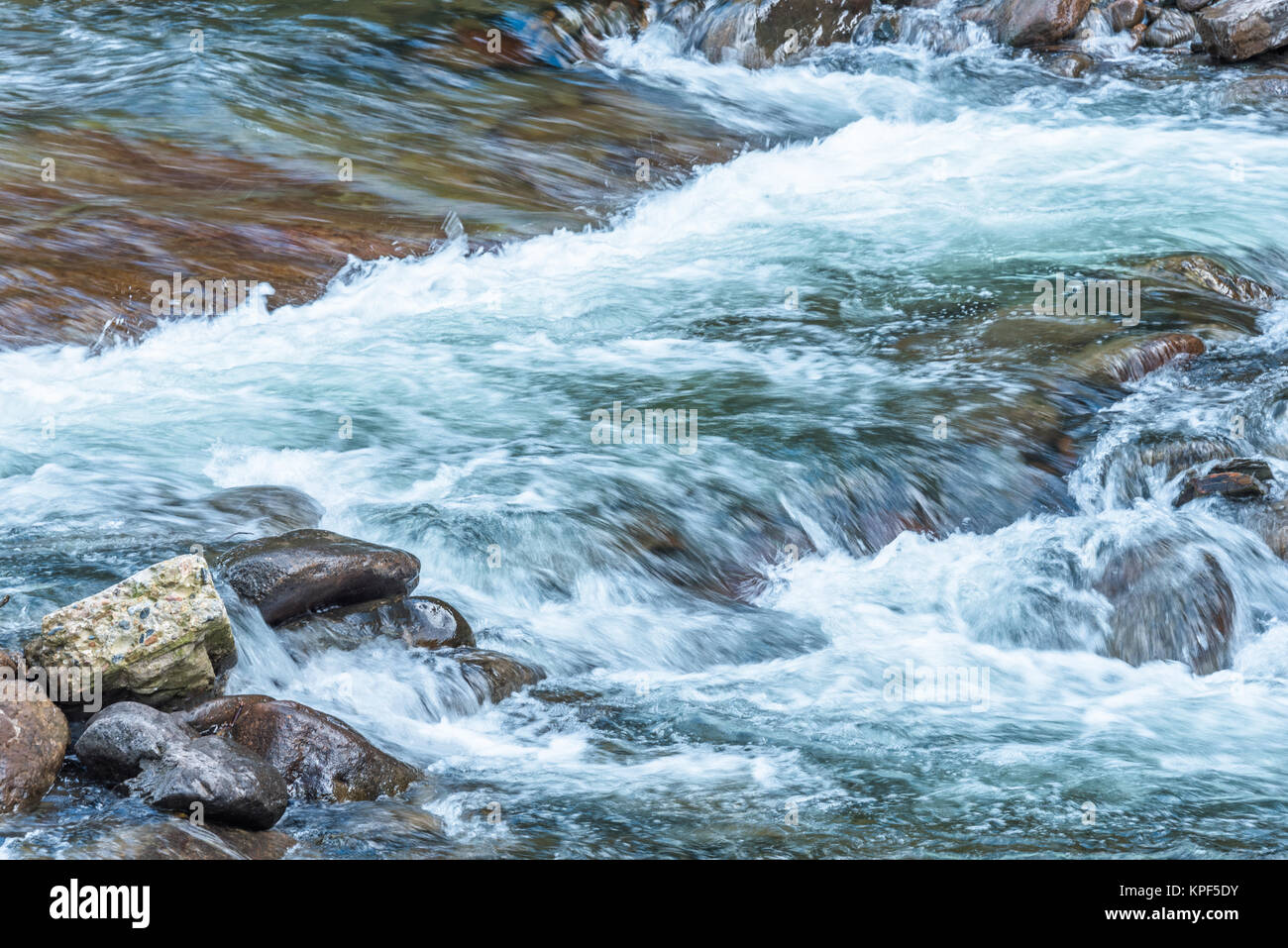 Stream Flowing Through Rocks in forest Stock Photo - Alamy