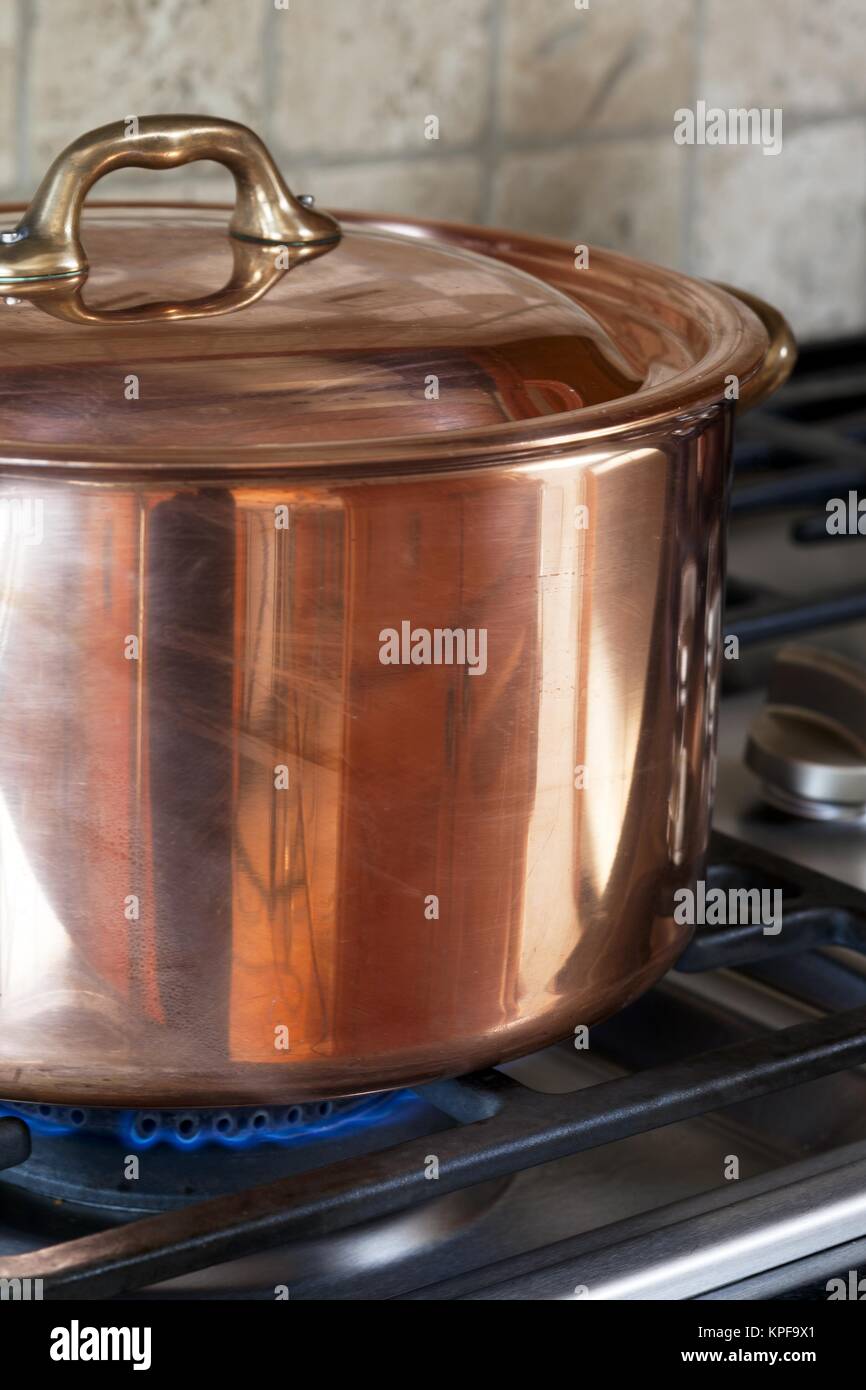 golden pot on a gas stove Stock Photo - Alamy