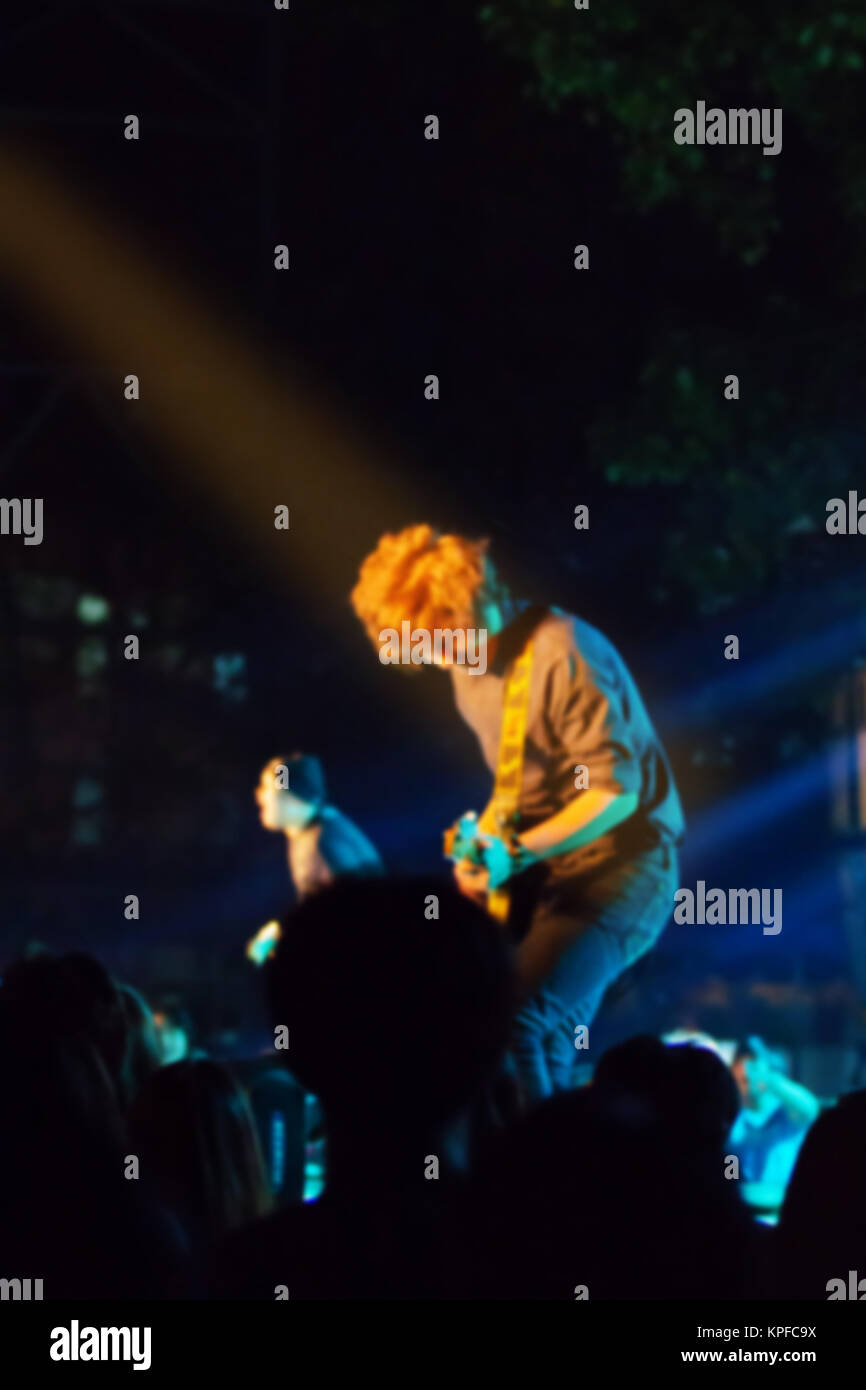 Blurred image of guitarist on stage in music festival Stock Photo - Alamy