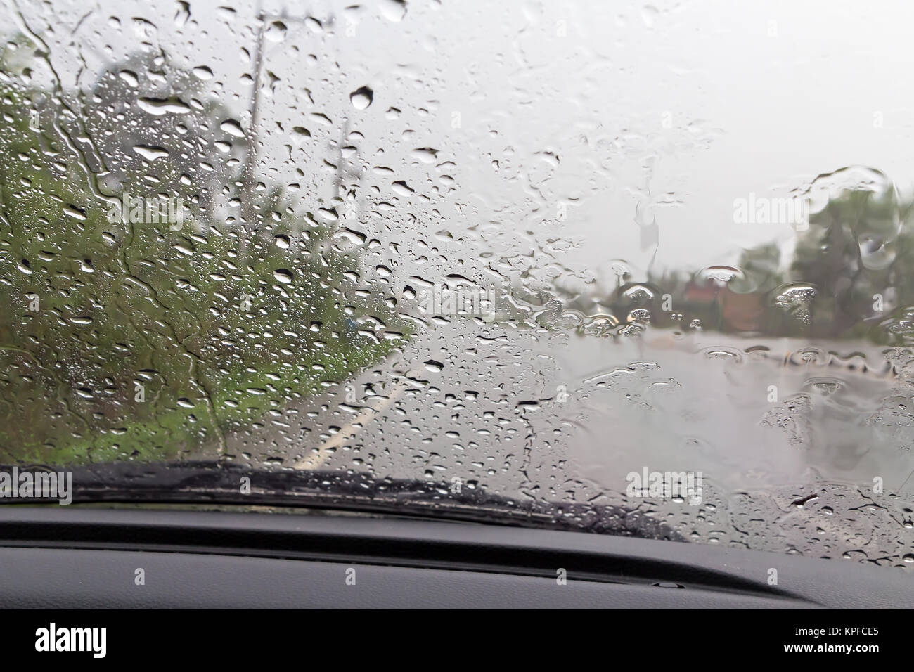 Road view through car windshield with rain drops, Driving in rain Stock ...