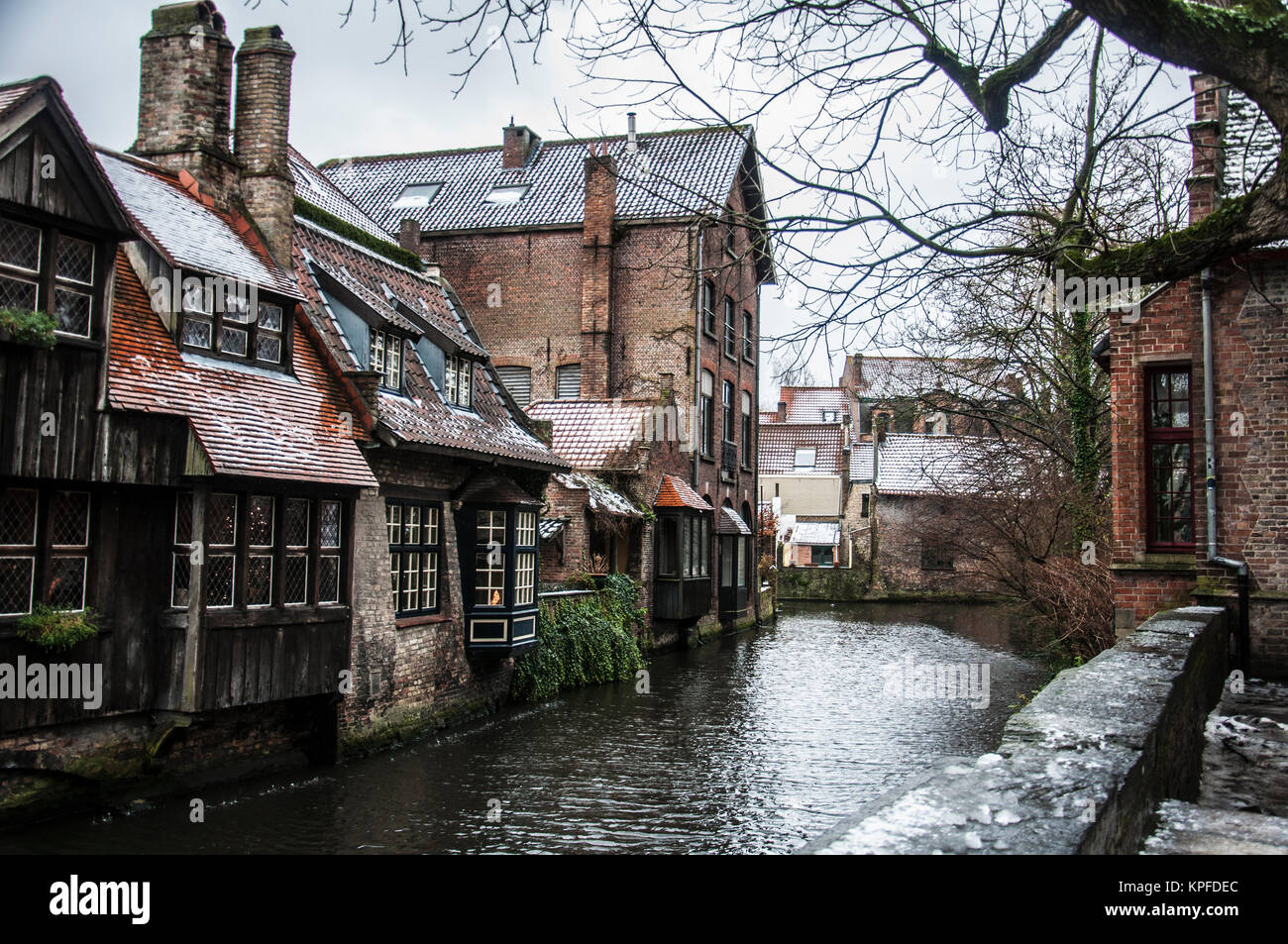 architecture and canal of brugge, snow, snowing day, bruges, belgium ...