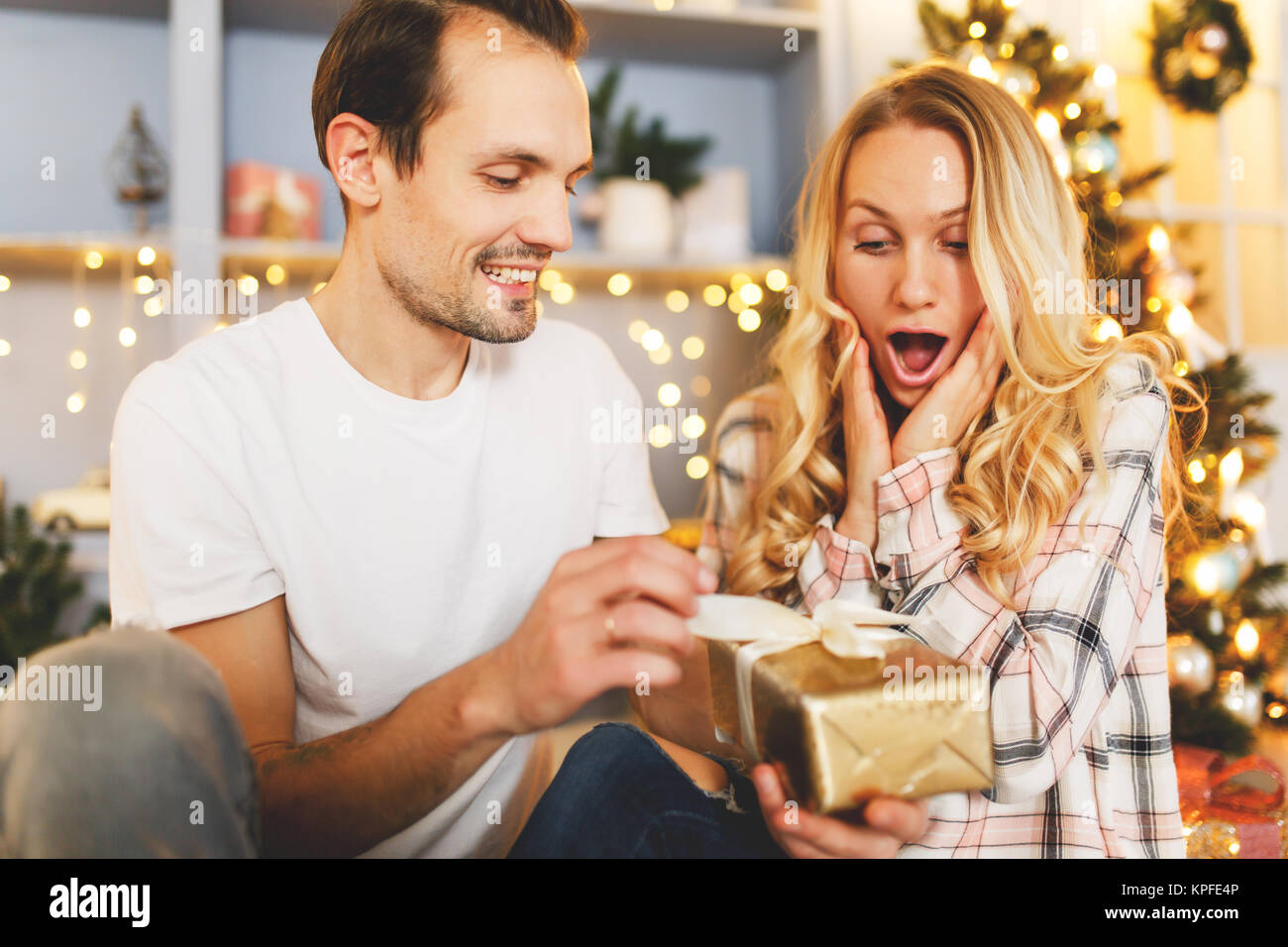 Man surprise woman for Chrismas Stock Photo - Alamy