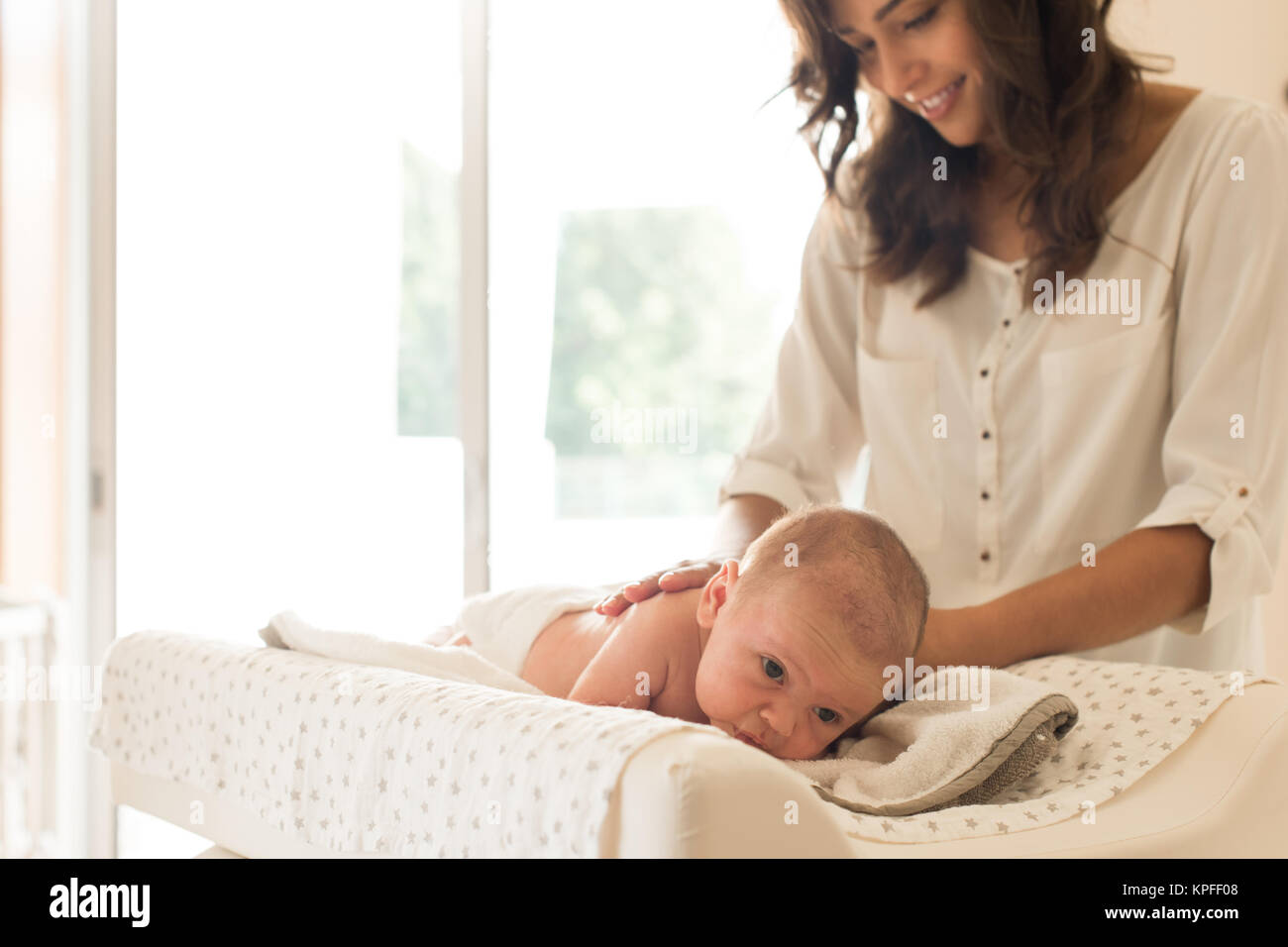 Mother changing a diaper on newborn baby Stock Photo - Alamy