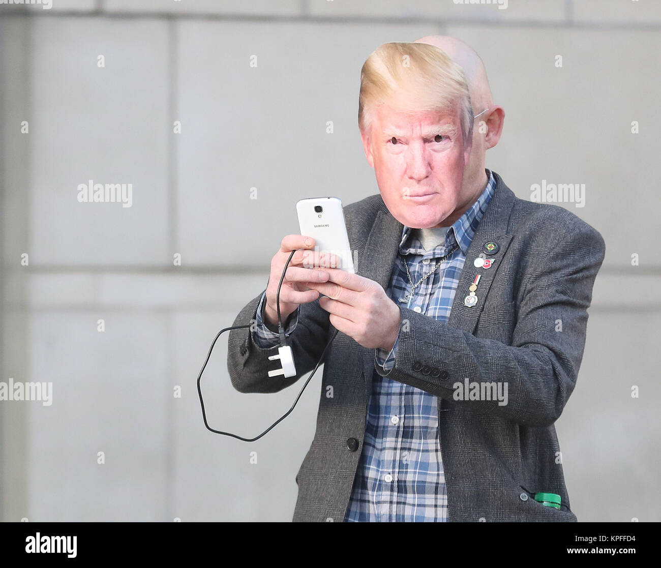 Britain First supporter Andrew Edge, wearing a Donald Trump mask, takes ...