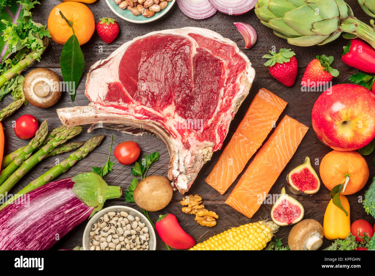 An overhead photo of various foods. Fresh vegetables, fruits, legumes ...