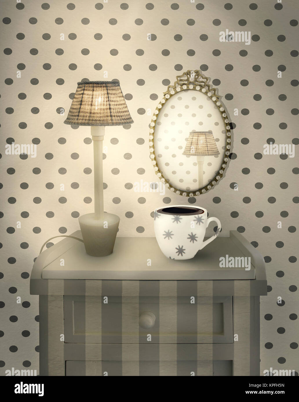 Beautiful interior detail of a bedside table with lighted lamp a cup ...